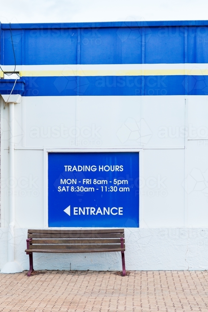 Image of Trading hours signage and seat outside country store ...