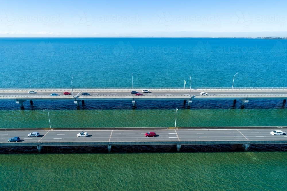 Image of Traffic driving on two bridges over water. - Austockphoto
