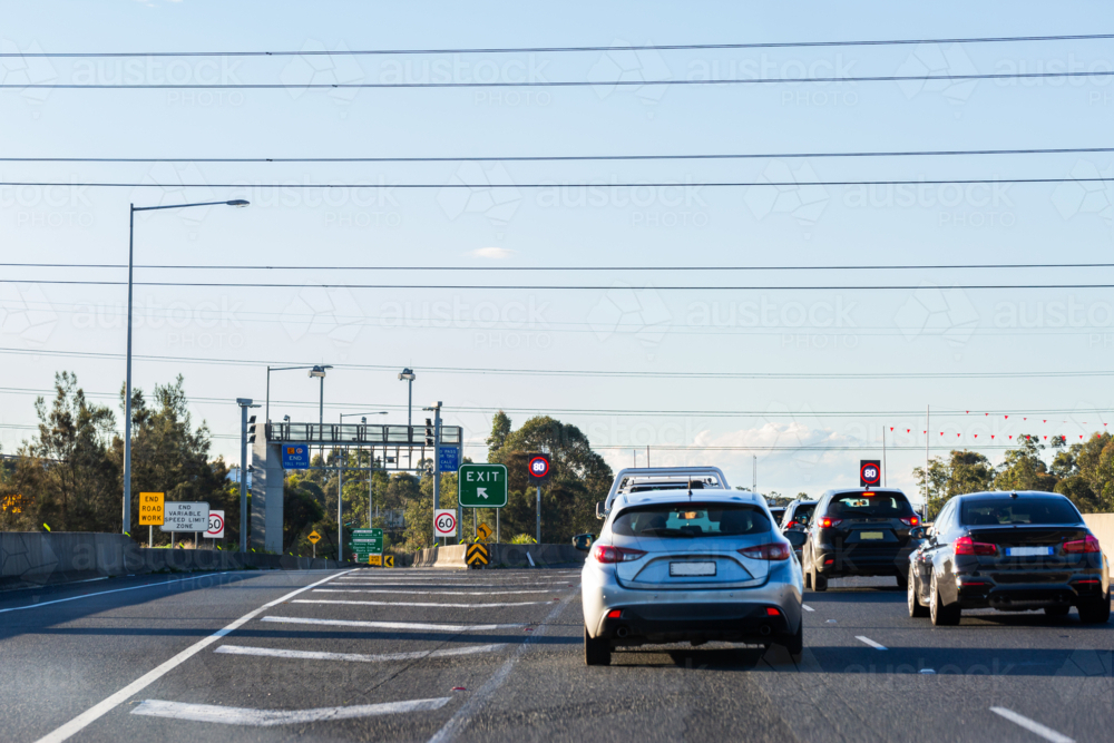 Image of Traffic on highway with end toll point on road exit - Austockphoto