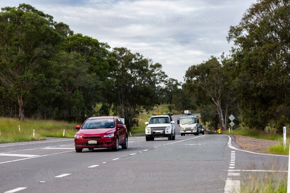 Image of traffic on rural highway in evening - Austockphoto