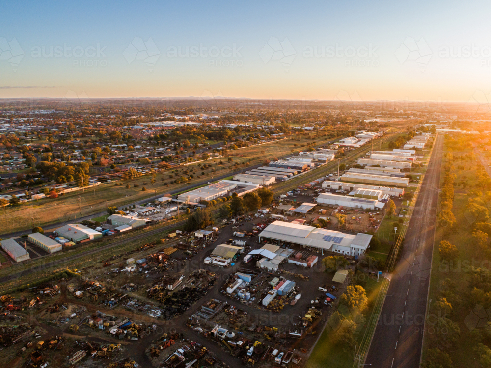 Image of Train line passing sheds in industrial aera in Dubbo at sunset ...