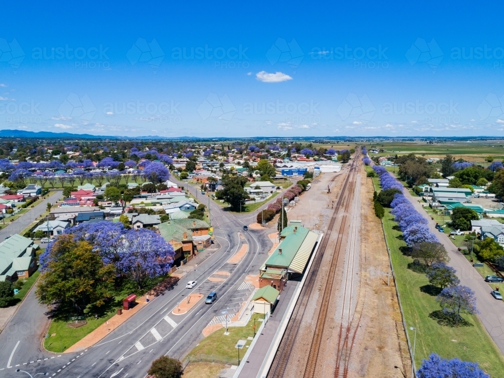 Image of Train track and singleton train station in spring with ...