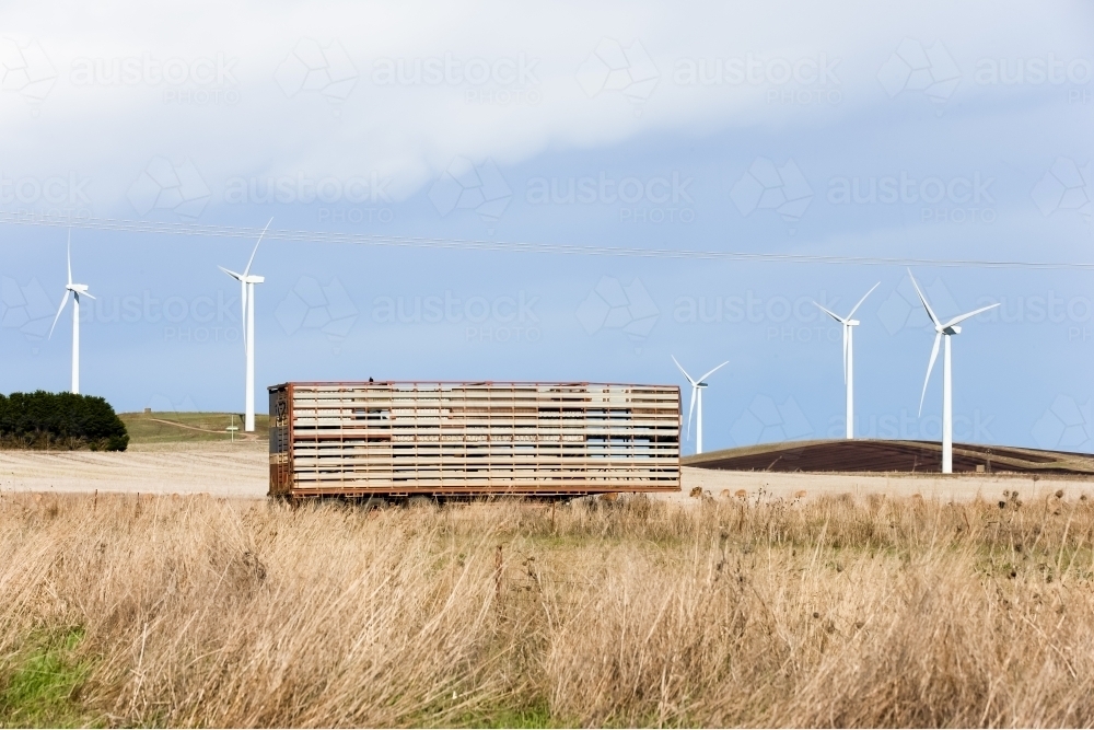 Image of Truck carriage with wind farm in background - Austockphoto