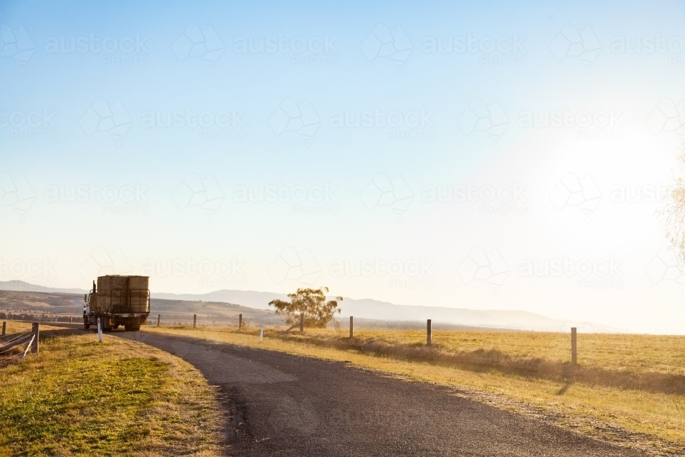 Image of Truck carrying hay along rural country road with copy space ...