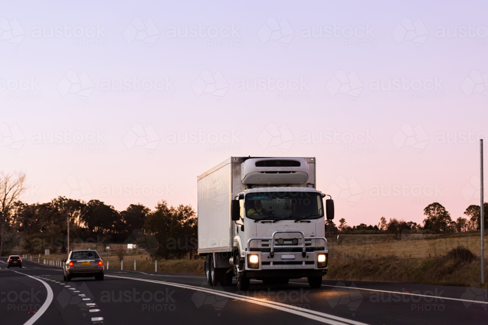 Image of truck transporting goods on highway at dusk through Australian ...