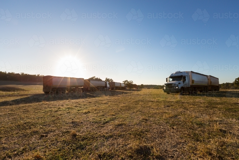 Image of Trucks in farm paddock - Austockphoto