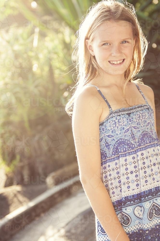Image of tween girl in blue summer dress - Austockphoto