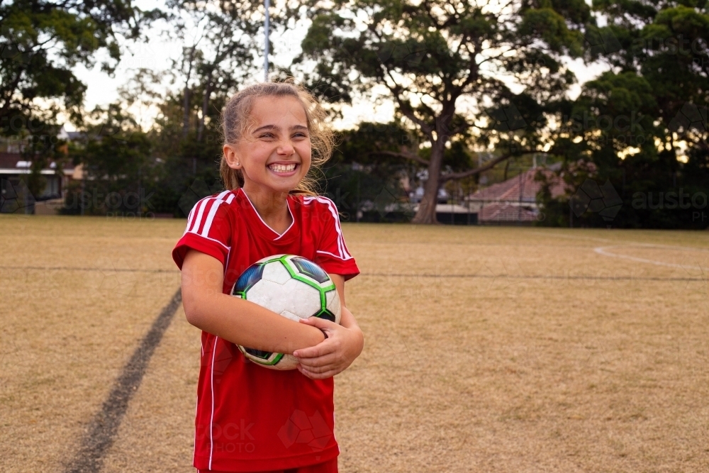 Image of Tween soccer player laughing with copy space - Austockphoto