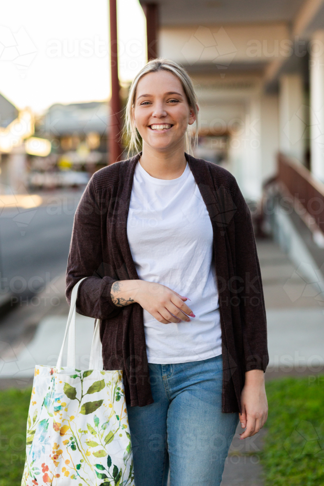 Image of twentysomething Australian woman walking portrait in urban ...