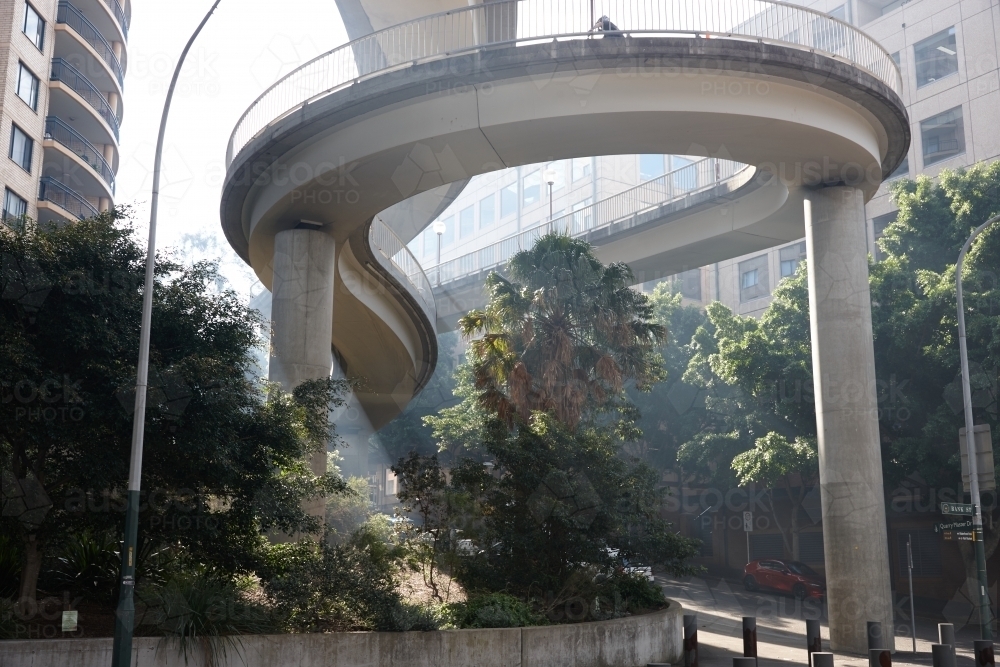 Image of Twisted ramp over trees in Sydney city - Austockphoto