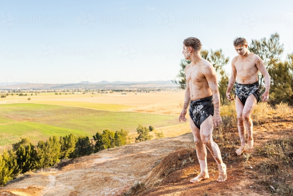 Image of Two Aboriginal Australians on country walking along the edge ...