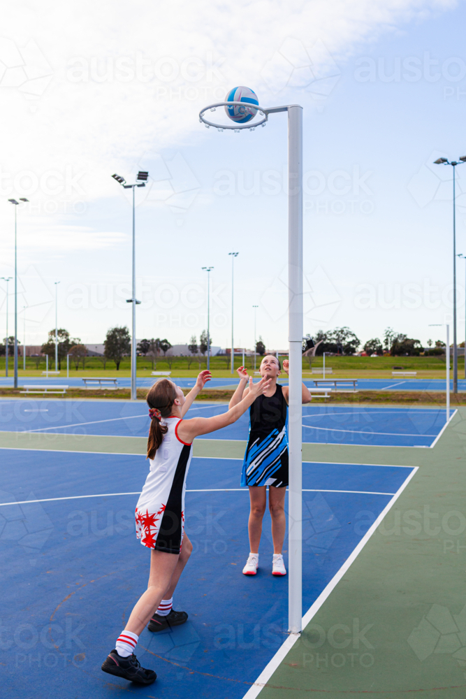 Image of Two aboriginal sisters at the court training for netball team ...