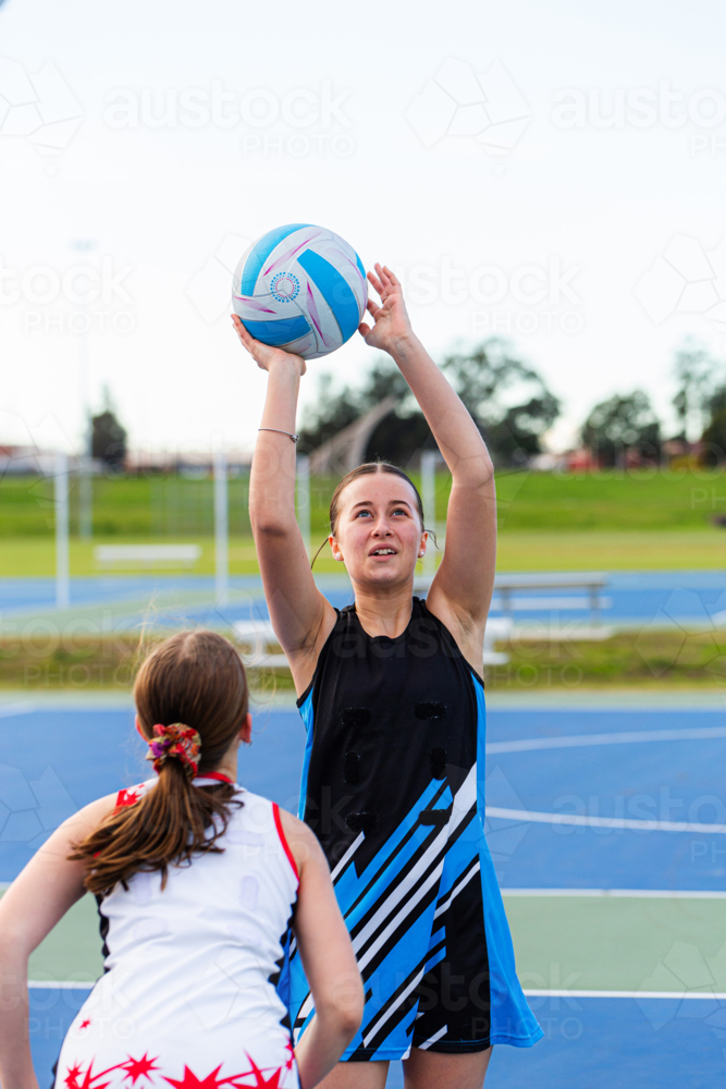 Image of Two aboriginal sisters at the court training for netball team ...