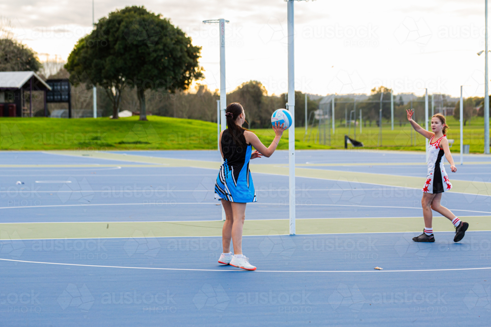 Image of Two aboriginal sisters at the court training for netball team ...