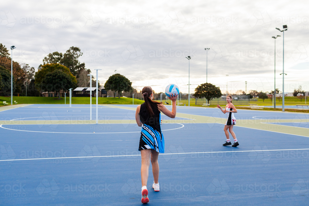 Image of Two aboriginal sisters at the court training for netball team ...