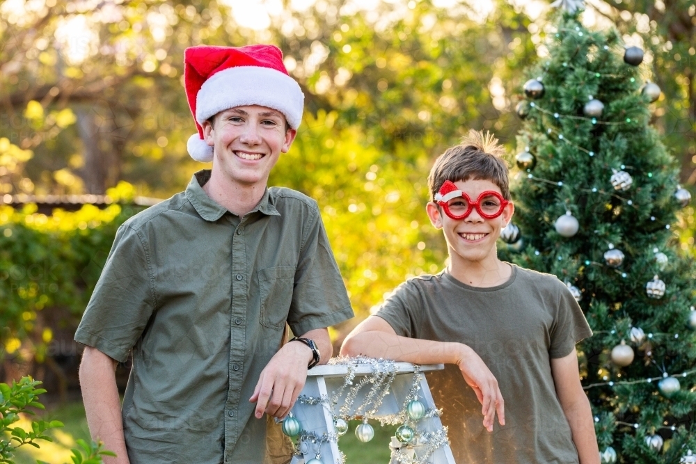 Image of Two Aussie boys wearing a silly Christmas hat and glasses ...