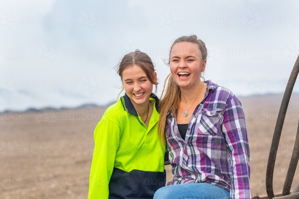 Image of Two country girls laughing with smoky background - Austockphoto