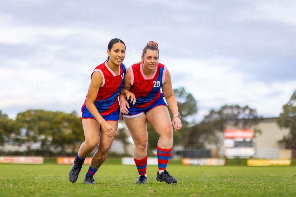 Image of two female footballers jostling for position at training ...