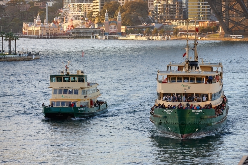 Image of Two ferries crossing the water besides the Harbour Bridge ...