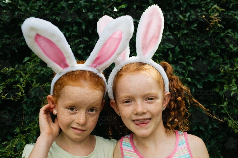 Image of Two girls with bunny ears - Austockphoto