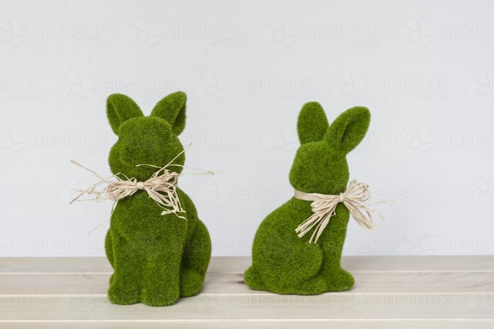 Image of Two green bunnys on a plain background - Austockphoto