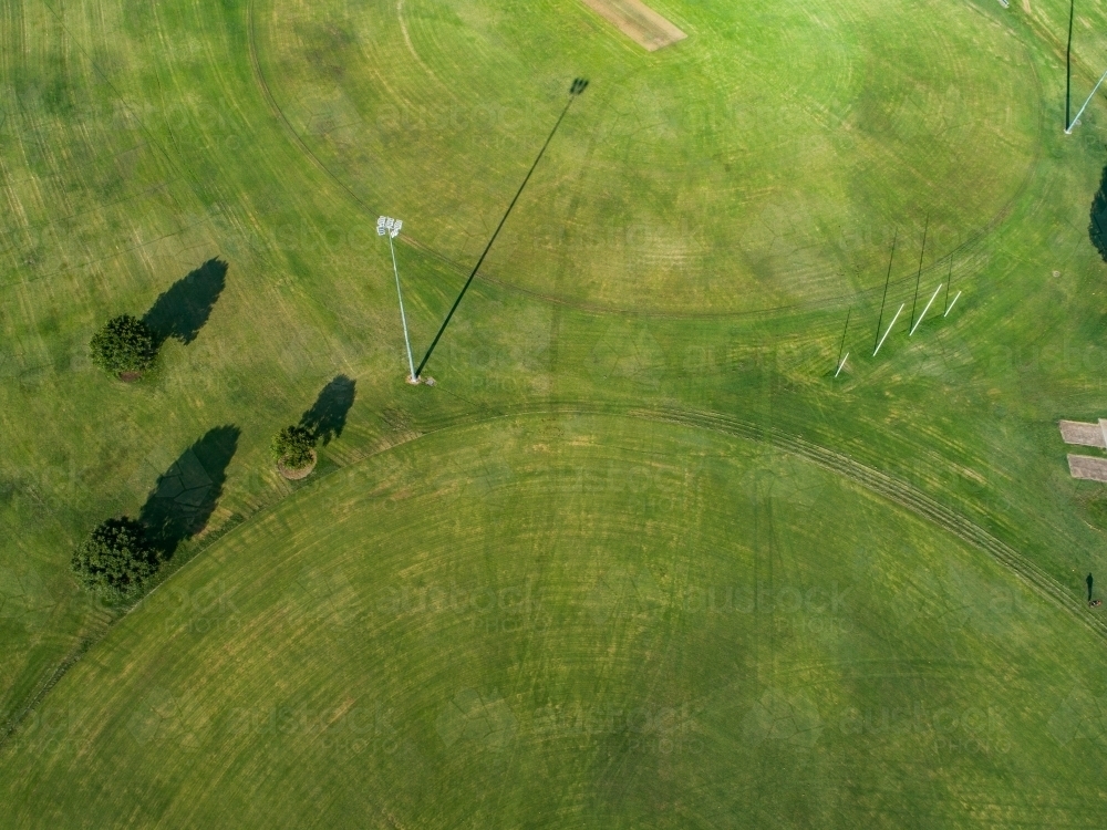 Image of Two green sports ovals in parkland seen from overhead with ...