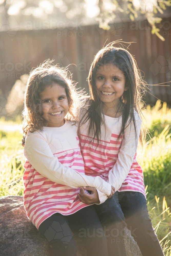 Image of Two happy Aboriginal girl sisters - Austockphoto