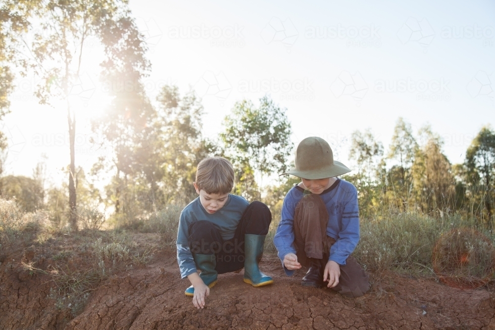 Image of Two happy Aussie kids playing outdoors in natural setting ...