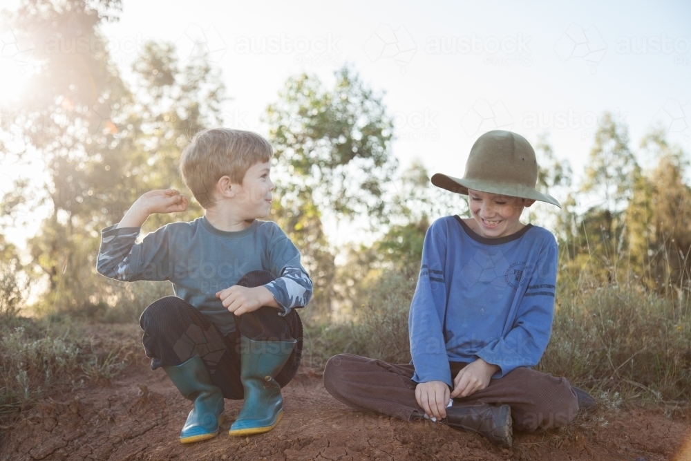 Image of Two happy Aussie kids playing outdoors in natural setting ...