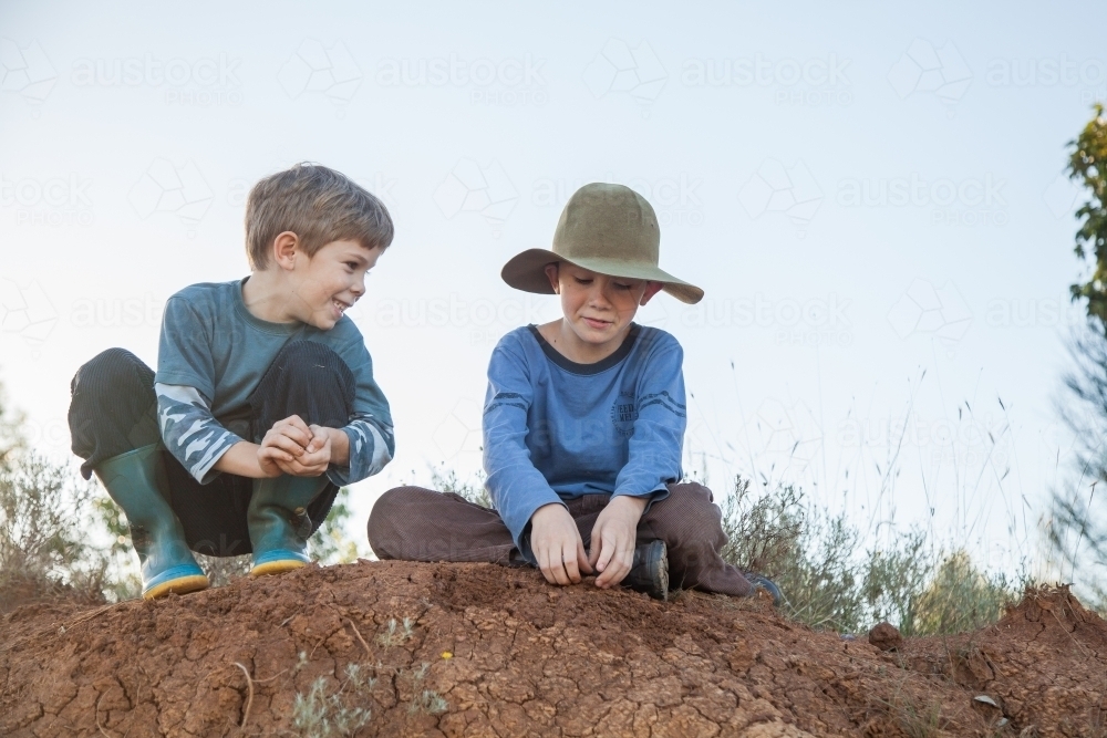 Image of Two happy Aussie kids playing outdoors in natural setting ...