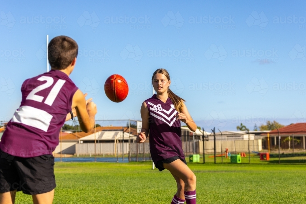 Image of two kids handballing at football training - Austockphoto