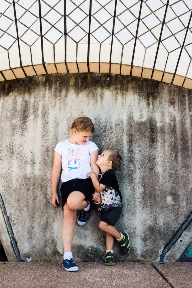 Image of two kids posing for photos at the base of sydney opera house ...