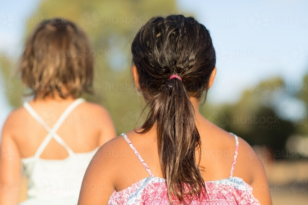 Image of Two little girls from behind - Austockphoto