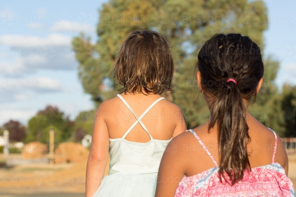 Image of Two little girls from behind - Austockphoto