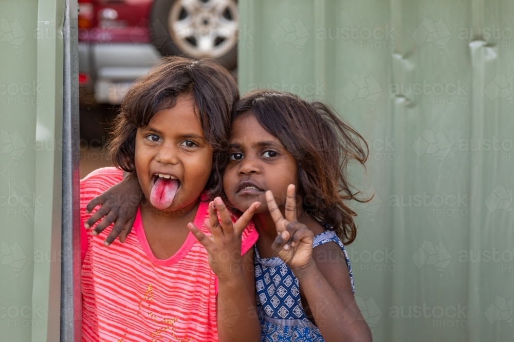 Image of two little kids making finger signs one sticking out tongue ...
