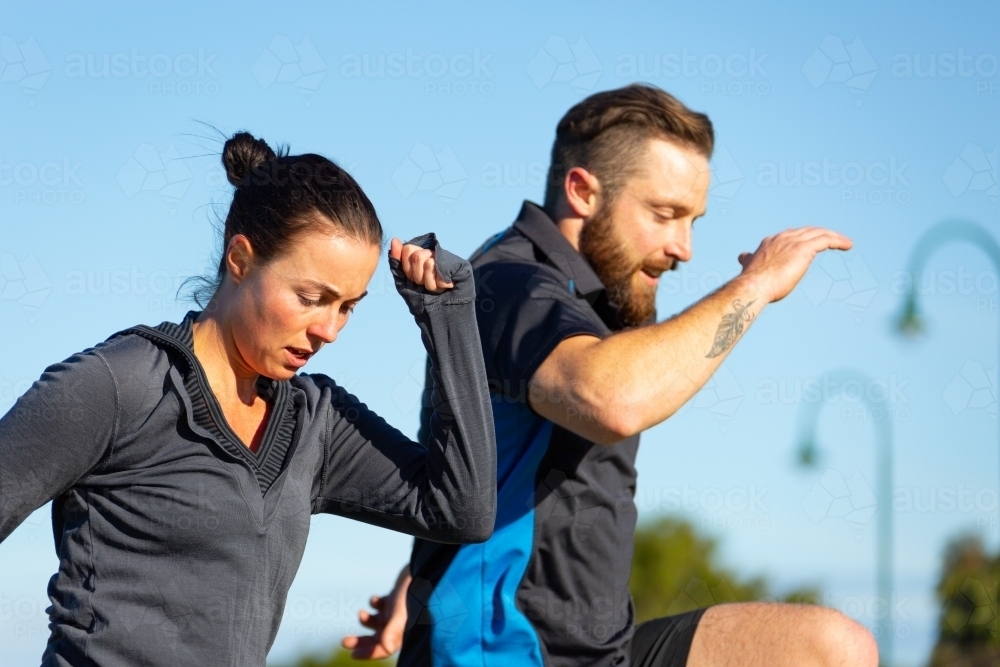 Image of Two people doing fitness exercises outdoors - Austockphoto