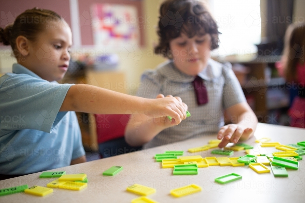 Image of Two primary girl students collaborating with coloured word ...