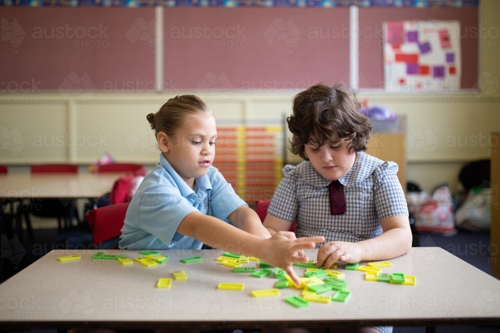 Image of Two primary school girl students collaborating with coloured ...