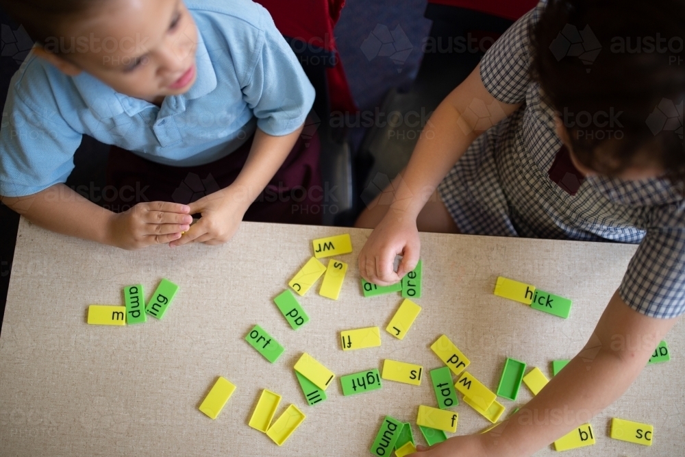 Image of Two primary school girl students collaborating with coloured ...