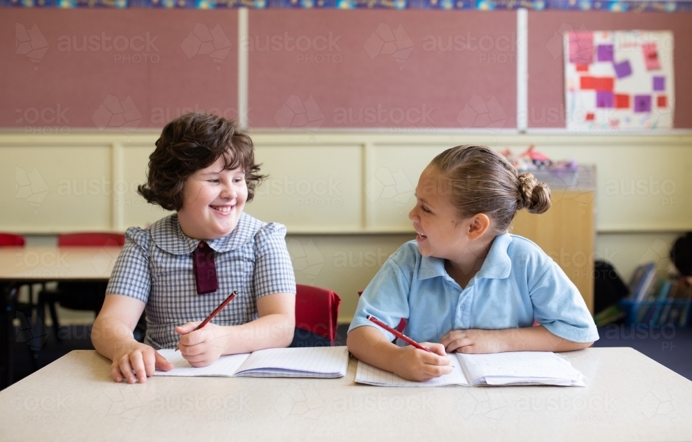Image of Two primary school girls working in a classroom together ...