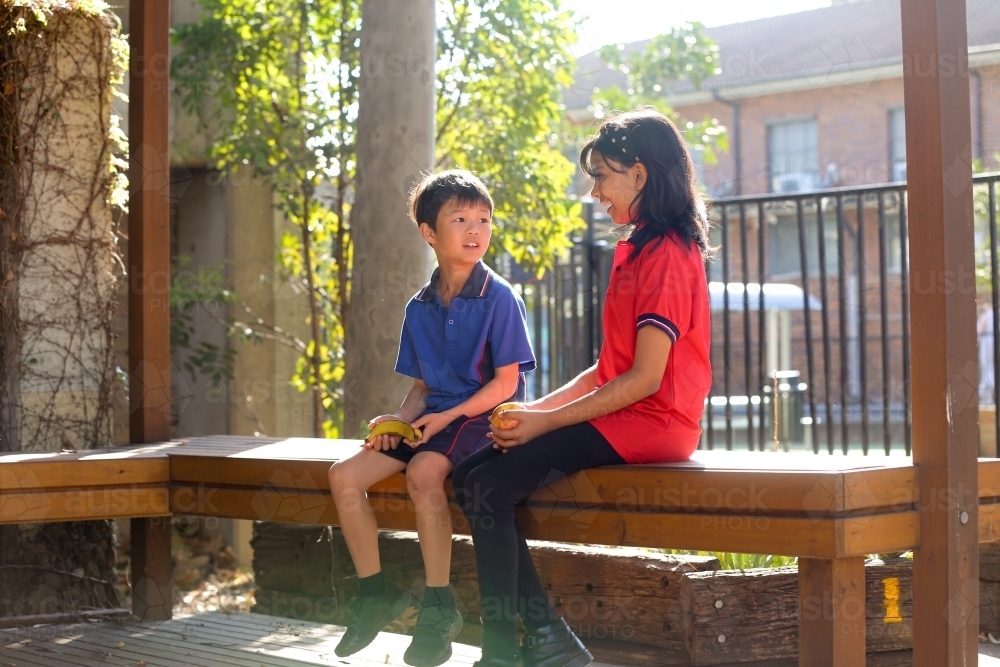 Image of two primary school students holding healthy food for fruit ...