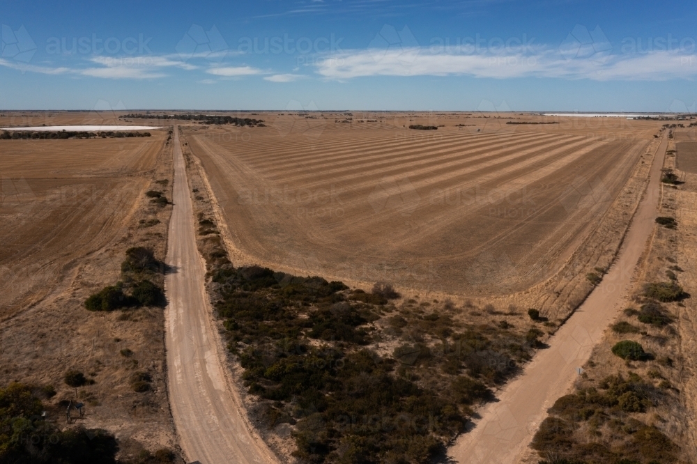 Image of two road veering off in diagonal direction, in a rural region ...