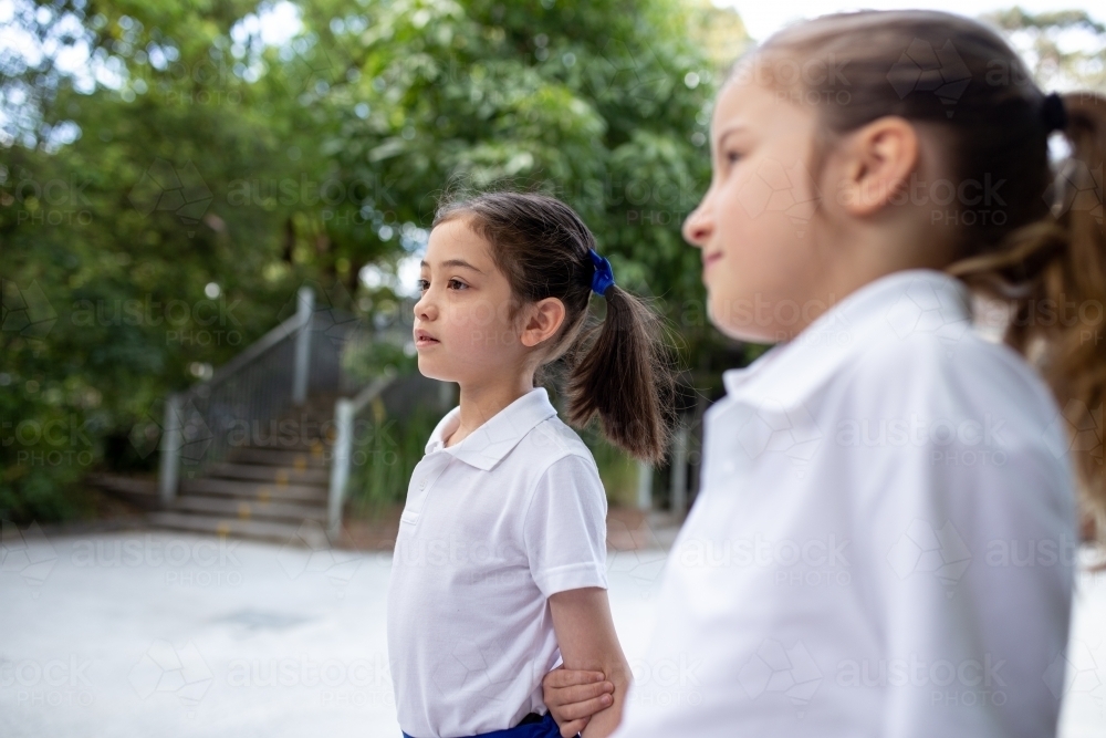 Image of Two Schoolgirls Together in Playground - Austockphoto