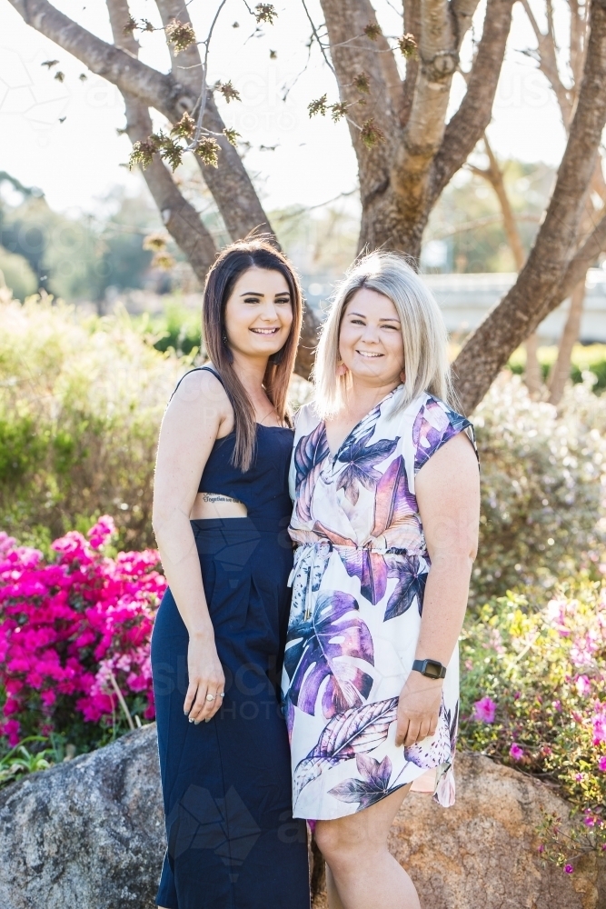 Image of Two sisters standing together smiling - Austockphoto