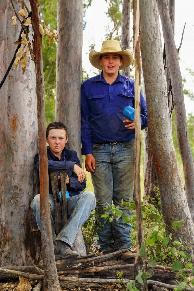 Image of Two teenage boys looking at camera on a farm. - Austockphoto