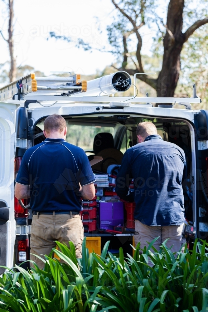 Image of Two tradesmen and their vehicle - Austockphoto