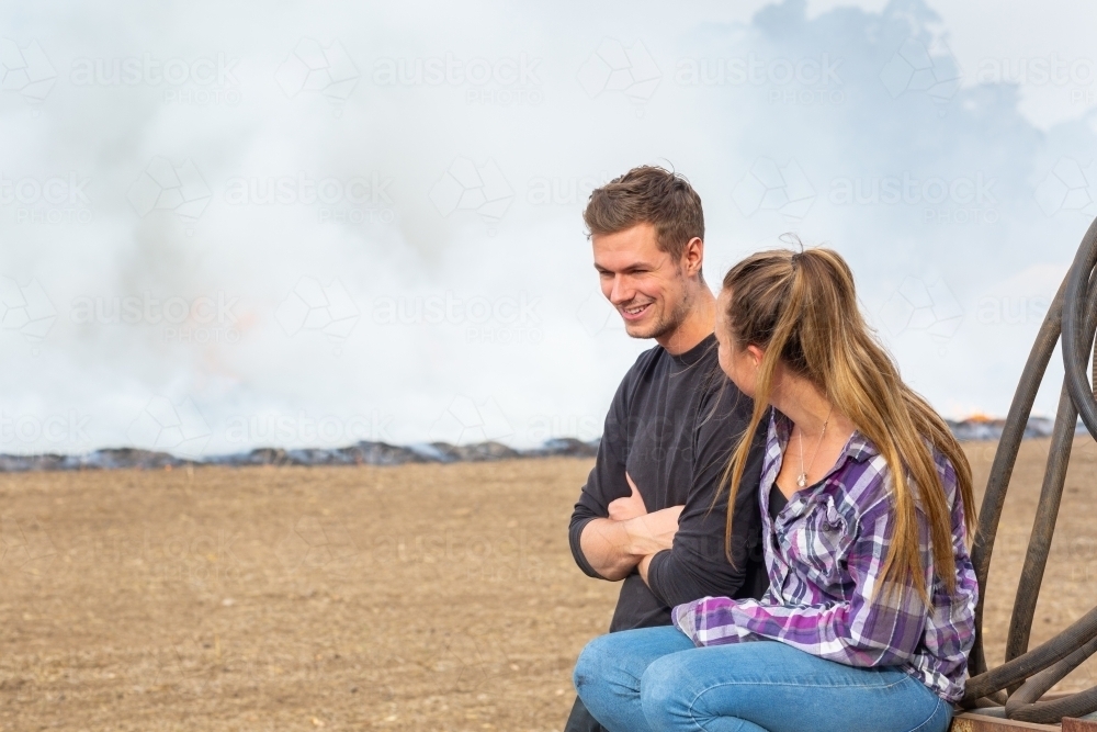 Image of Two young adults in rural setting with smoky background ...