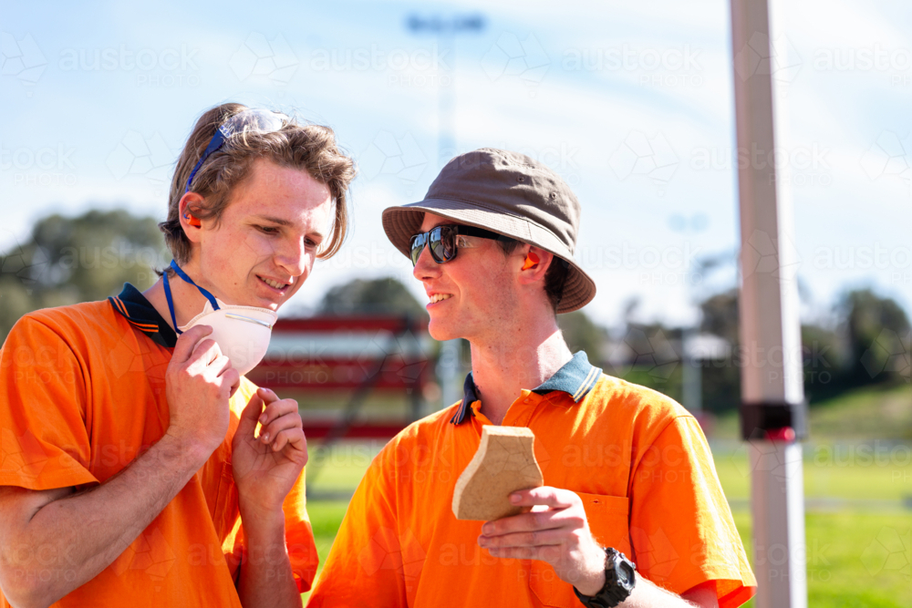 Image of Two young Aussie blokes laughing together during trade ...