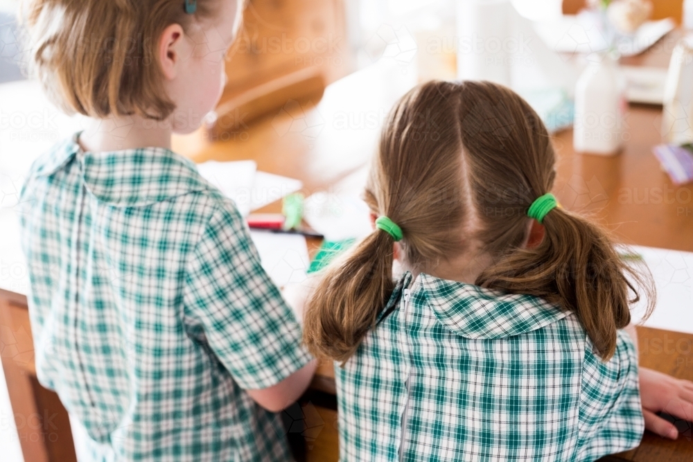 Image of Two young school girls from behind - Austockphoto