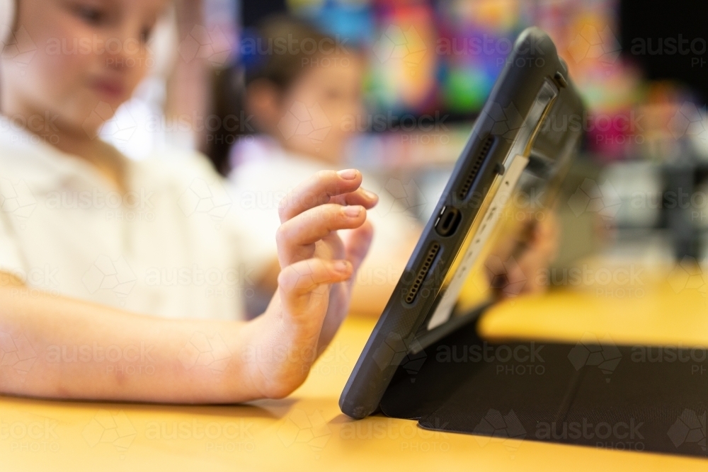 Image of Two Young Schoolgirls Learning on iPads - Austockphoto